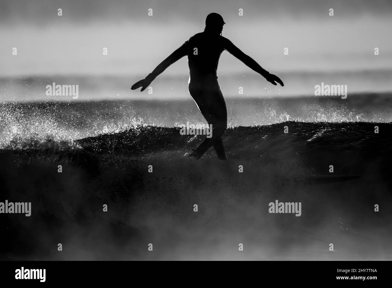 Surfer catching the big wave in the sea Stock Photo - Alamy