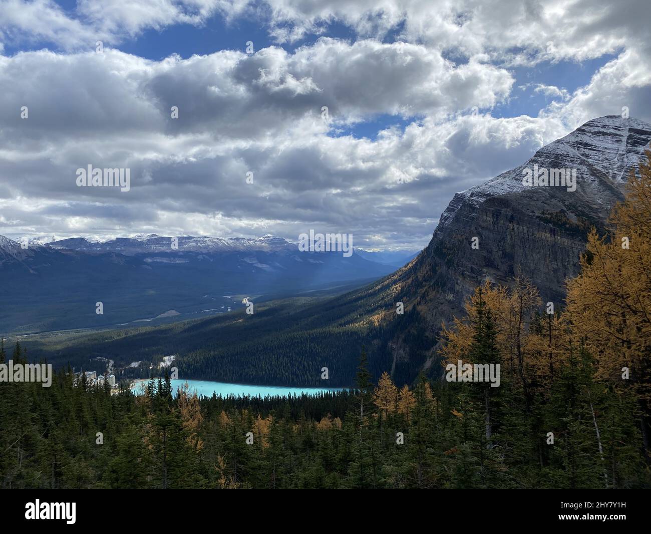 Scenic view of a lake hidden by dense forests and a tall mountain on a ...