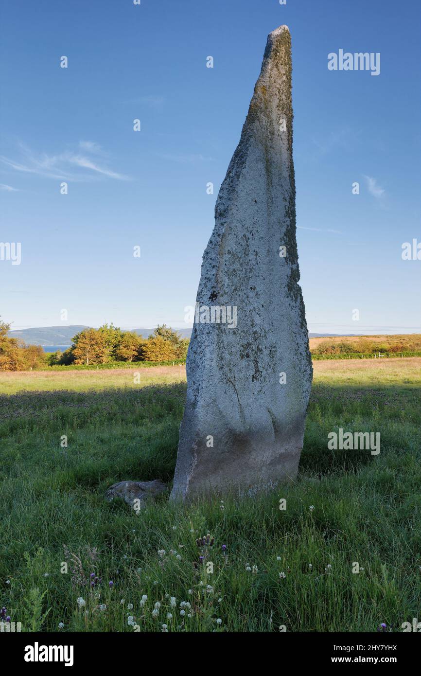 Vertical shot of a stone monolith in the Isle of Arran on a blue sky ...