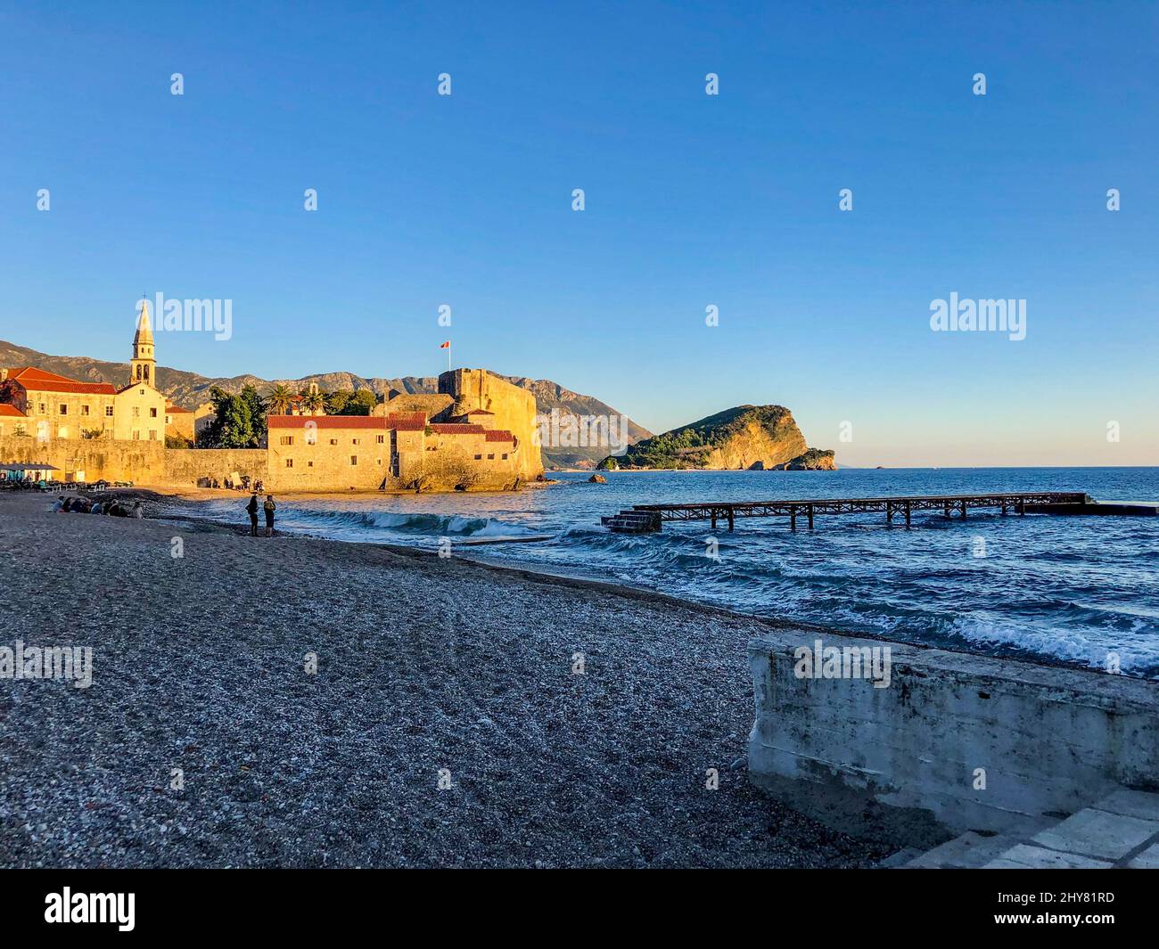 Beautiful scene of a sandy beach and the Budva, Montenegro castle on a ...