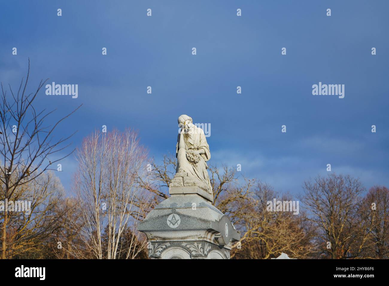 Thinking woman statue surrounded by leafless trees Stock Photo - Alamy