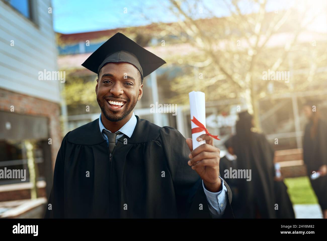 My success story starts here. Portrait of a happy young man holding a ...
