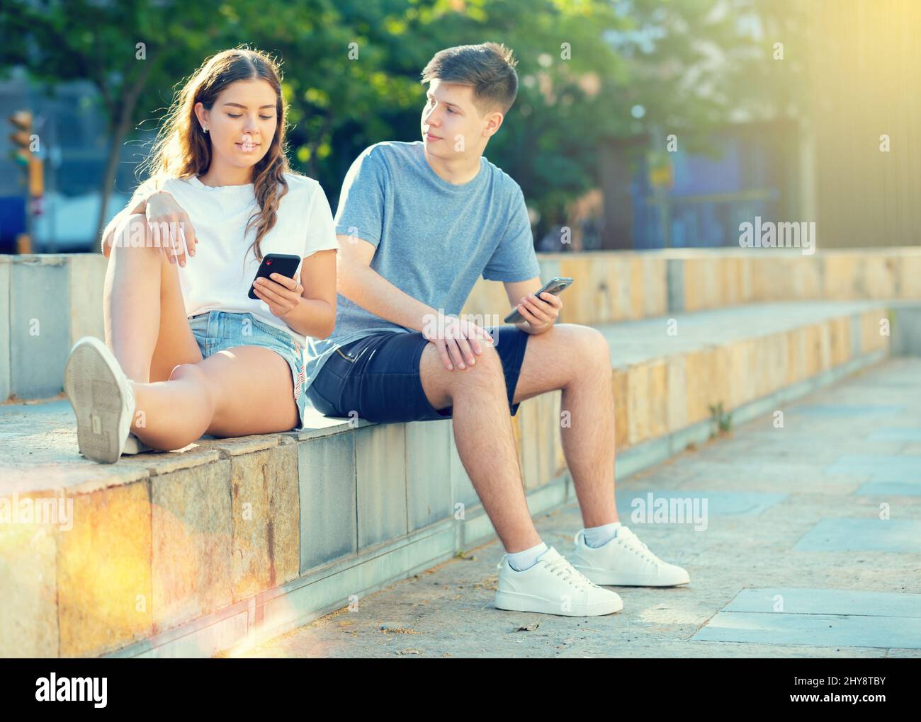 Two young people with mobile phones Stock Photo - Alamy