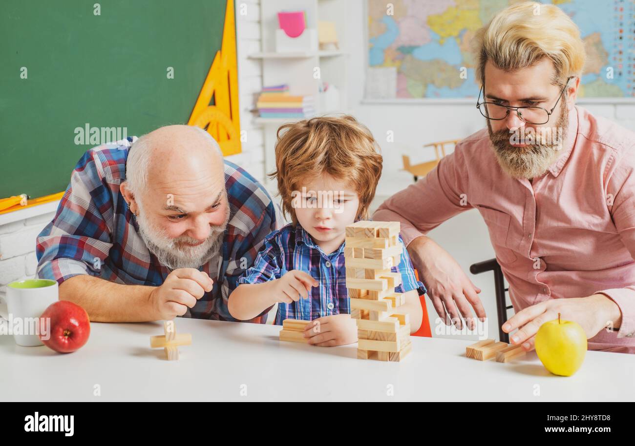 Jenga game at home. Happy generational muti three generation men family ...