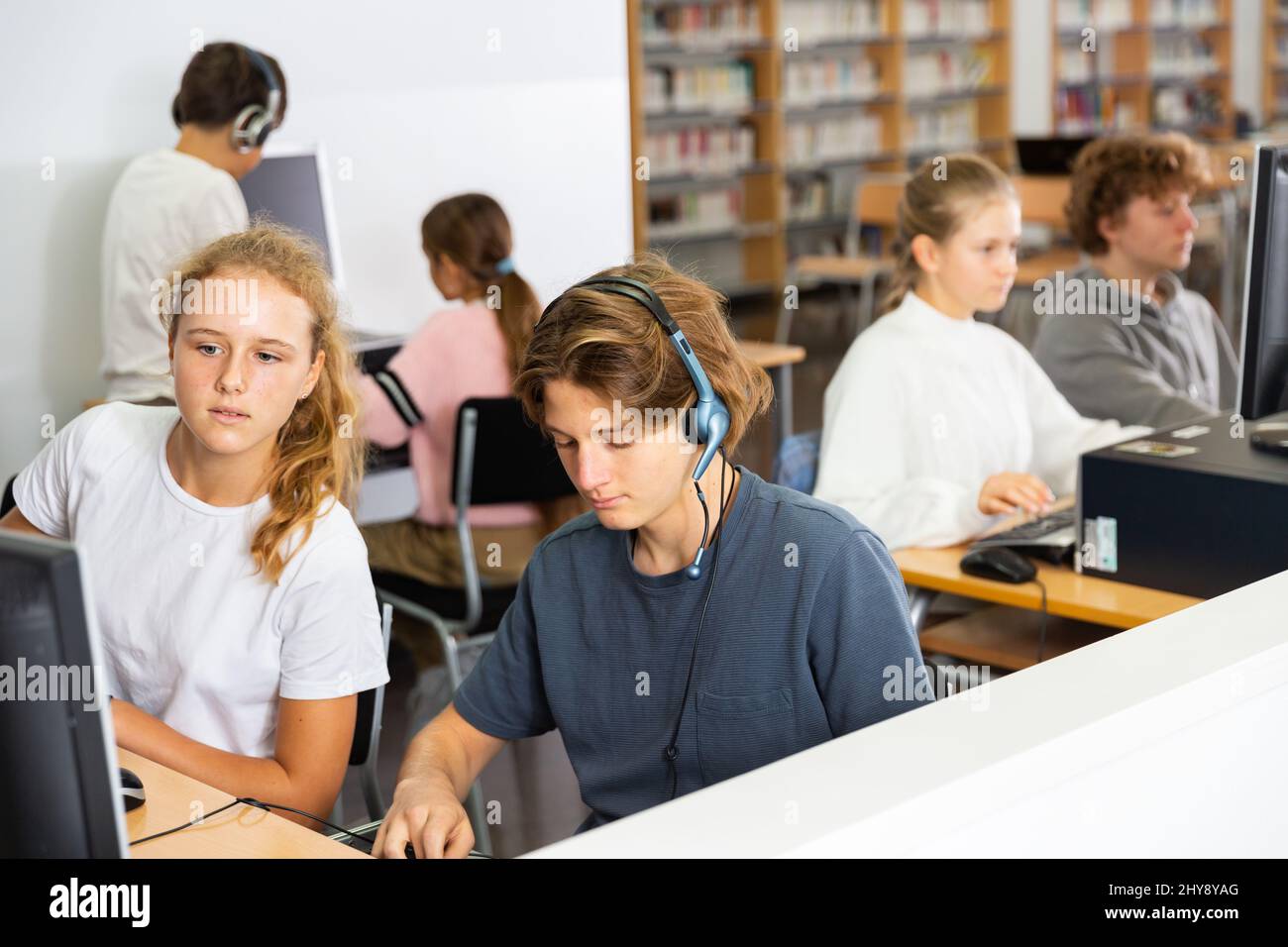 Teenager girls and boys studying in computer lab Stock Photo - Alamy