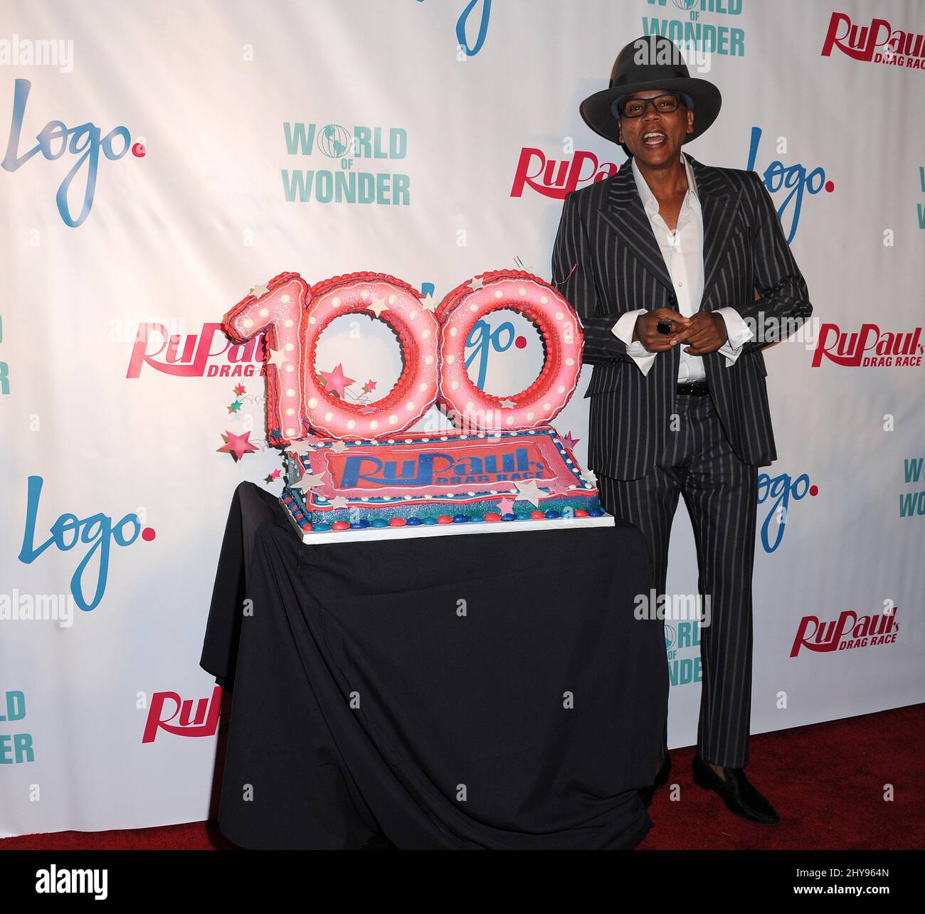 RuPaul stands next to a cake celebrating 100 episodes of RPDR during ...