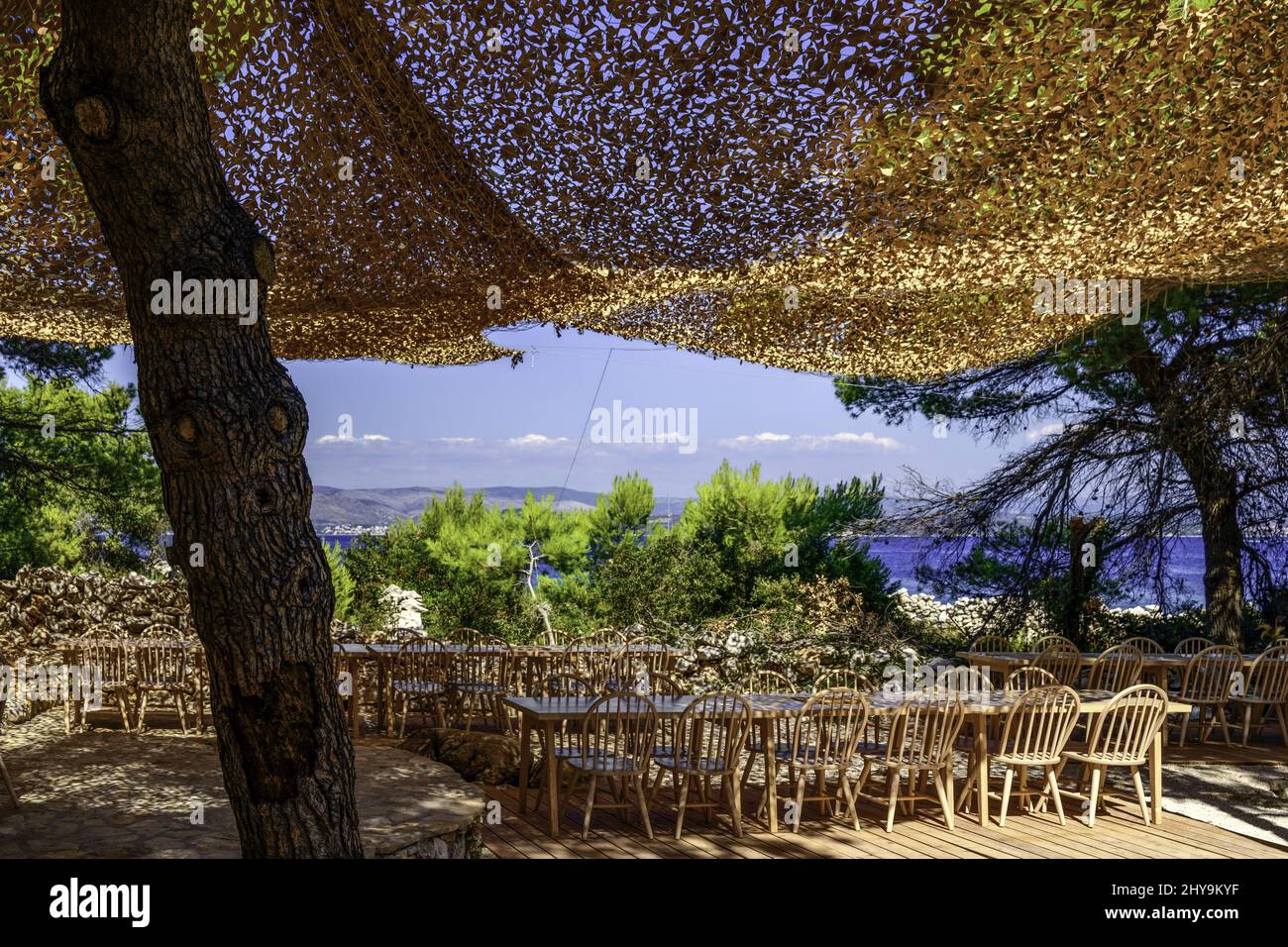 Open-air event hall surrounded by trees with a view of the sea Stock ...