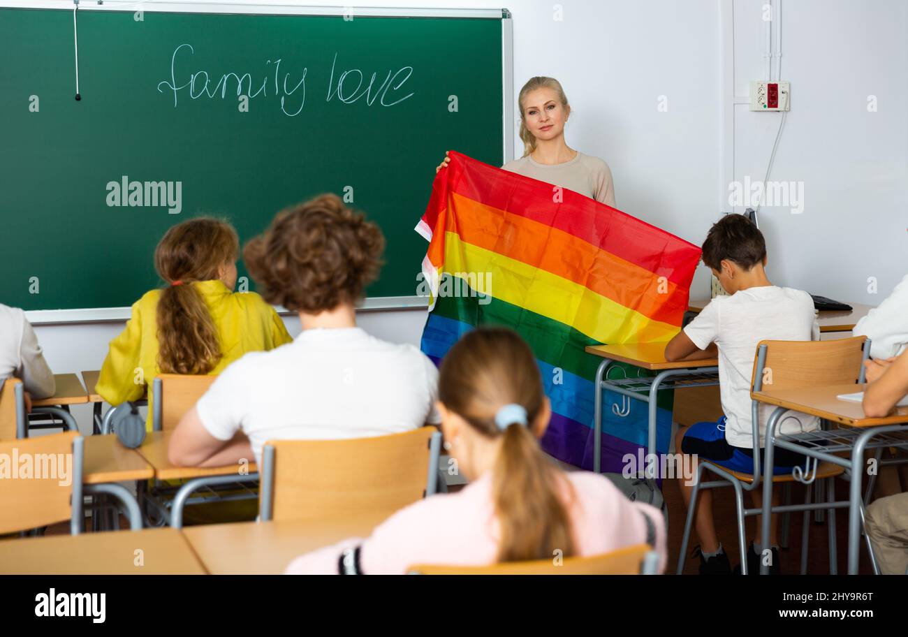 Teacher explaining lgbt theme to children during lesson Stock Photo - Alamy