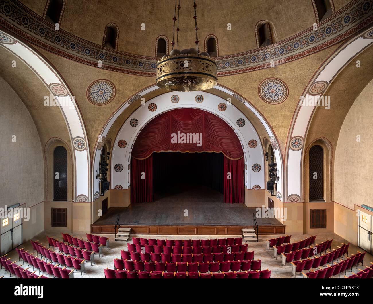 Big concert hall with red chairs in Jerusalem Stock Photo - Alamy