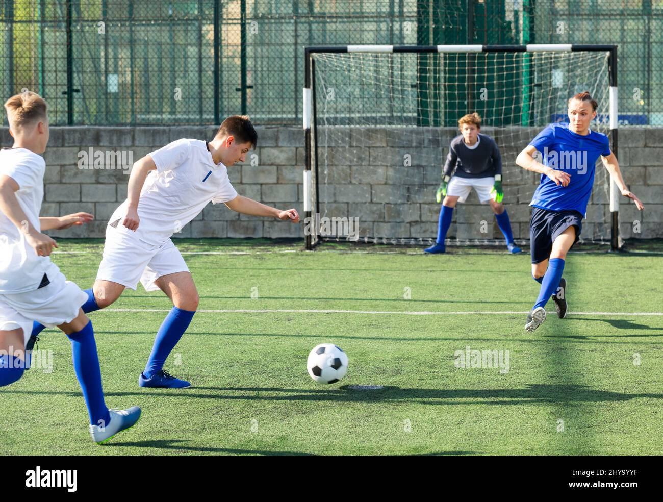 Young football players fighting for ball Stock Photo - Alamy