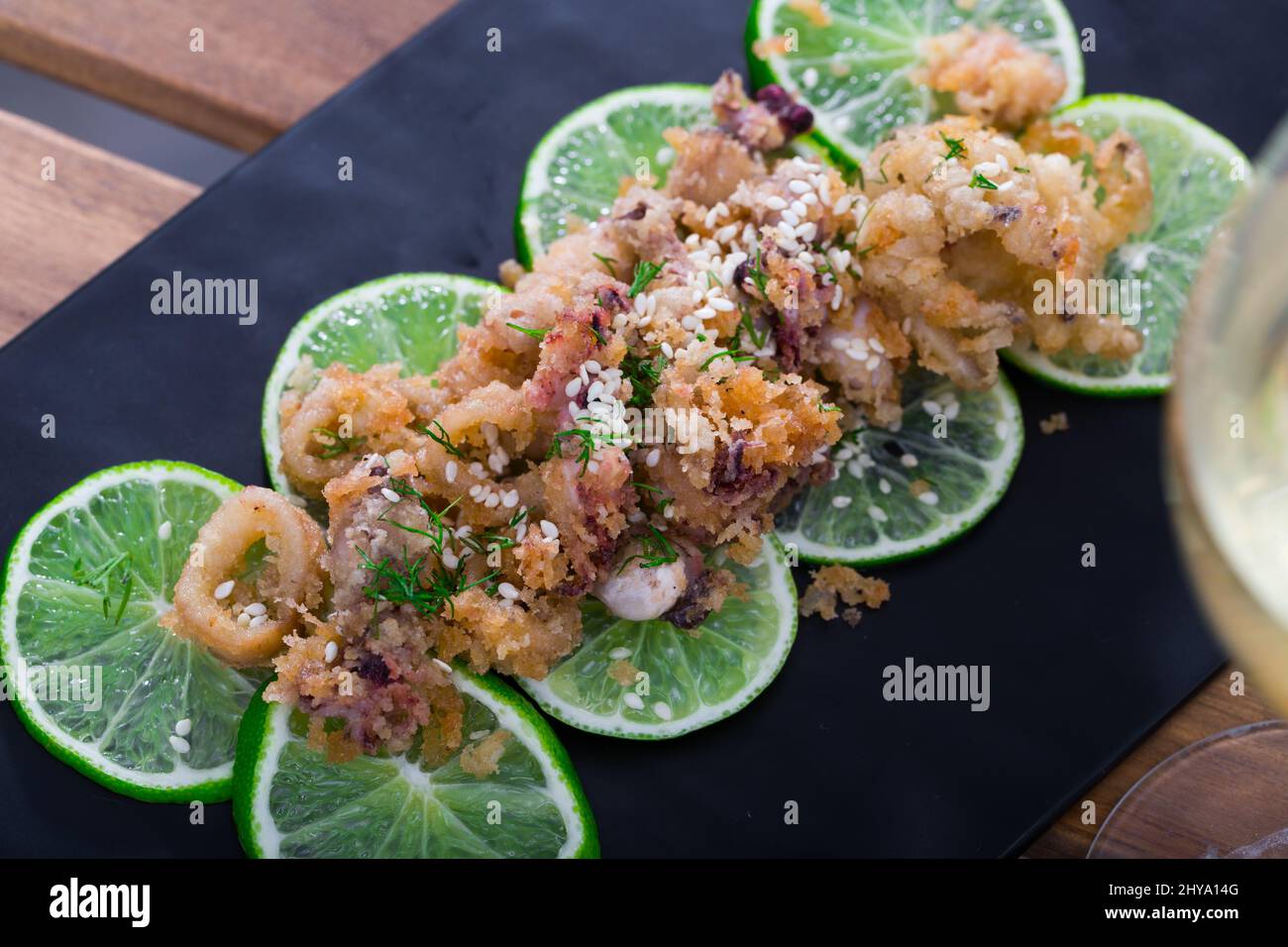 Battered calamari and cuttle with lime Stock Photo - Alamy