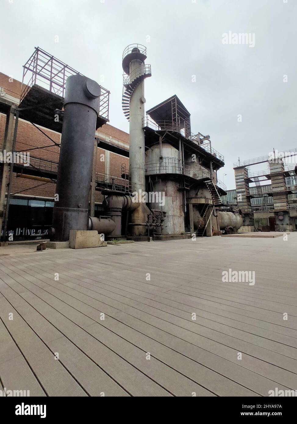 Vertical shot of industrial towers in an old factory Stock Photo - Alamy
