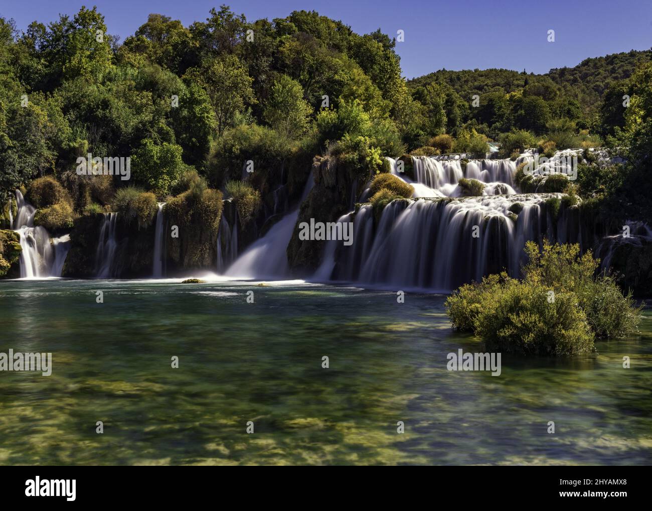 Beautiful shot of Skradinski Buk waterfall with moss and trees in Krka National Park, Croatia ...