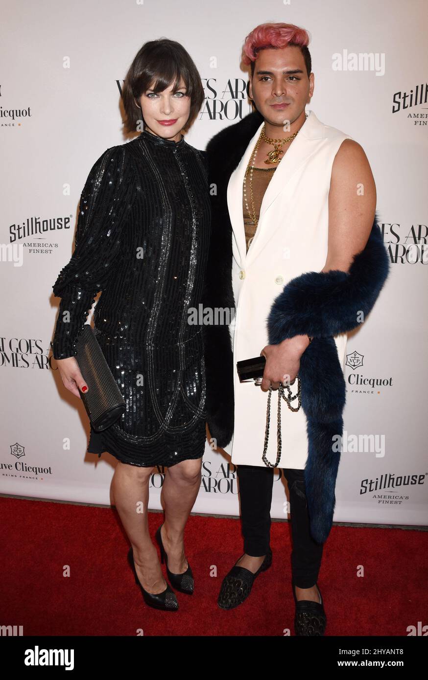 Milla Jovovich and Markus Molinari attending the What Goes Around Comes ...