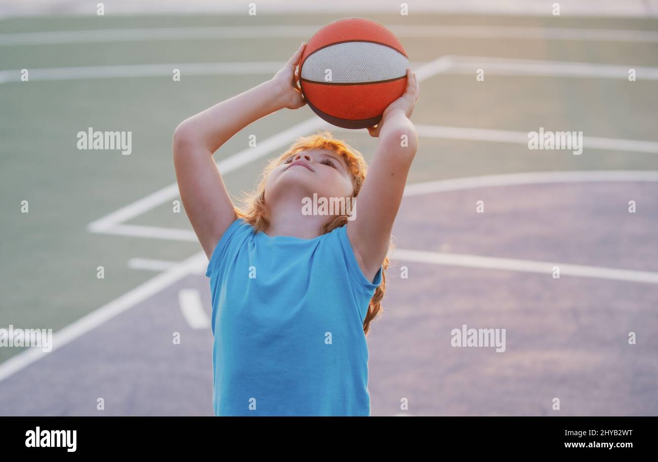 Kid playing basketball with basketball ball. Healthy children lifestyle ...