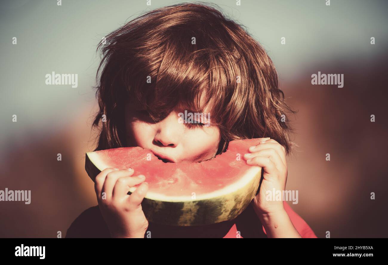 Close-up portrait of cute little child eating sweet watermelon ...