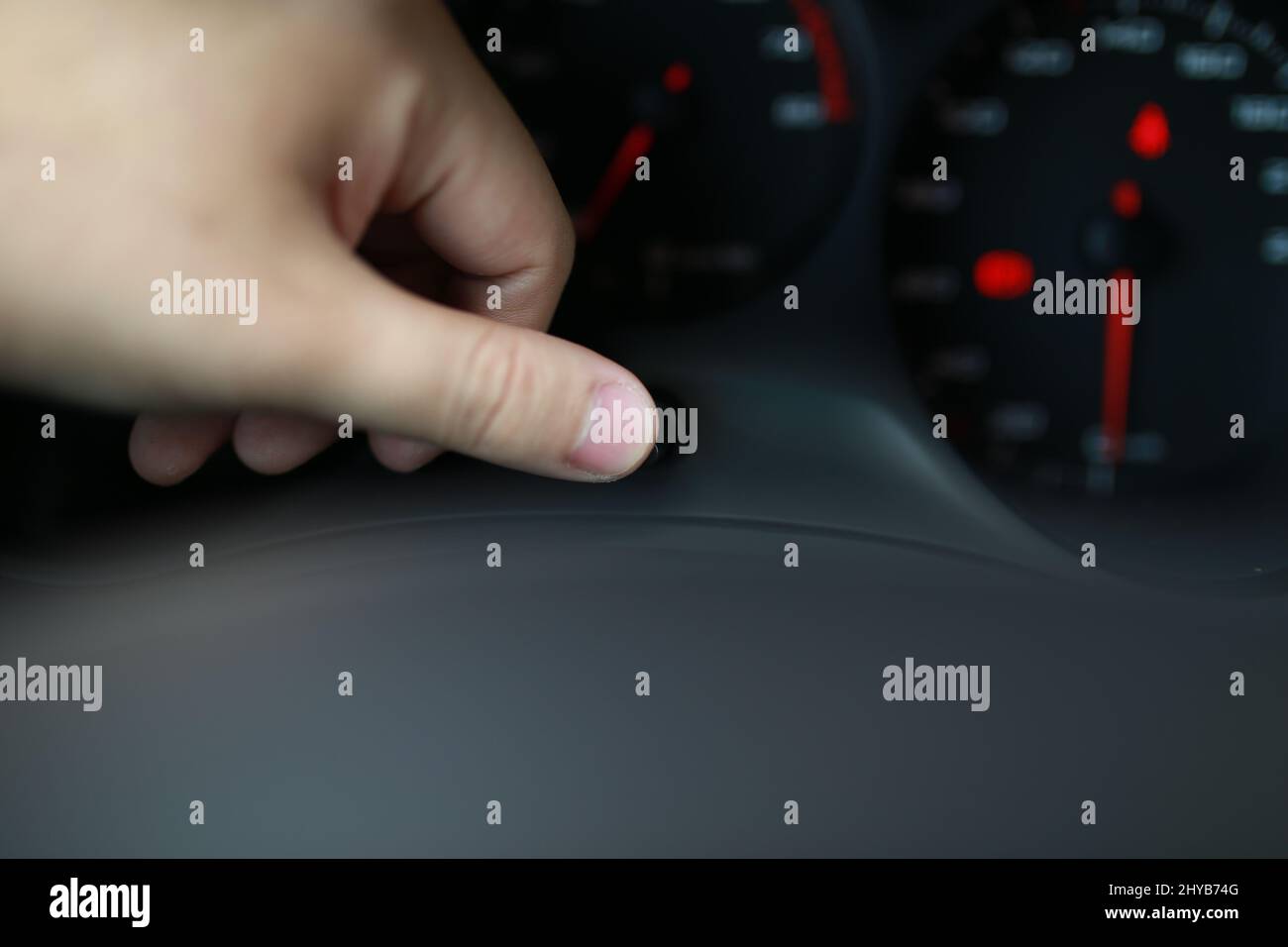 Closeup shot of a human hand in a car with the speed screen in the ...