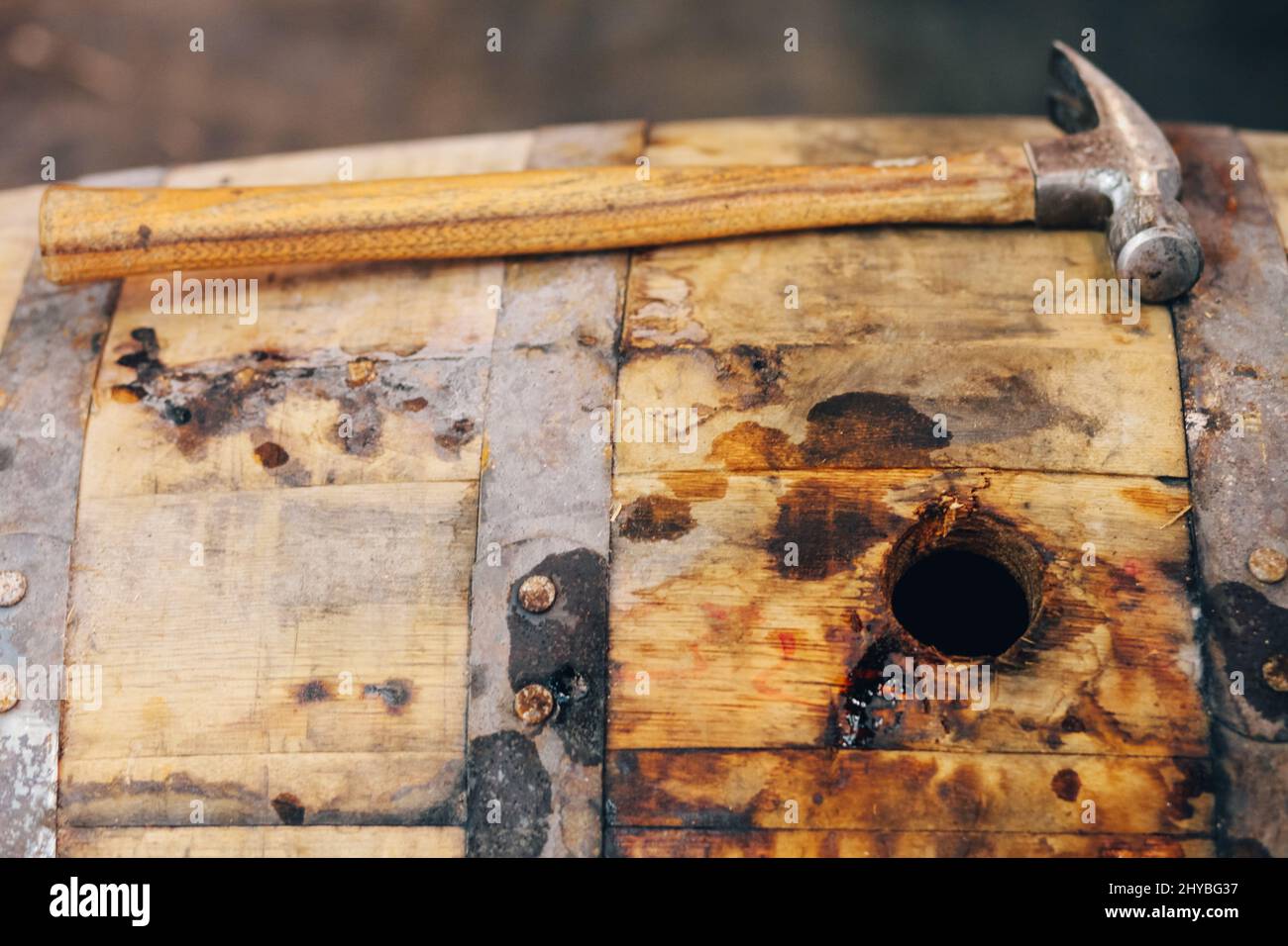 Hammer on dusty whiskey barrel with open bung hole Stock Photo - Alamy