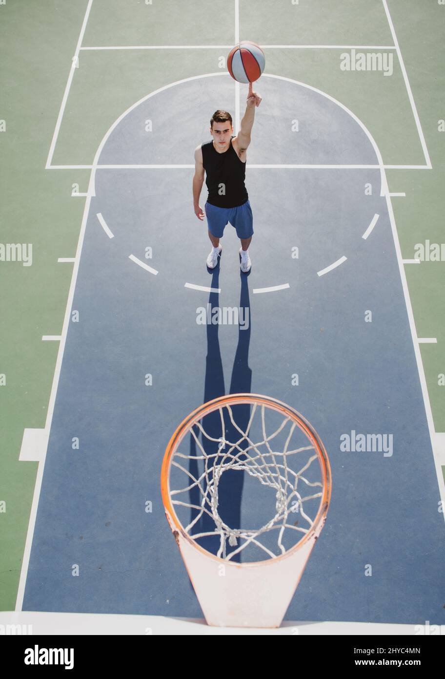 Basketball player shooting ball in hoop outdoor court. Urban youth game ...