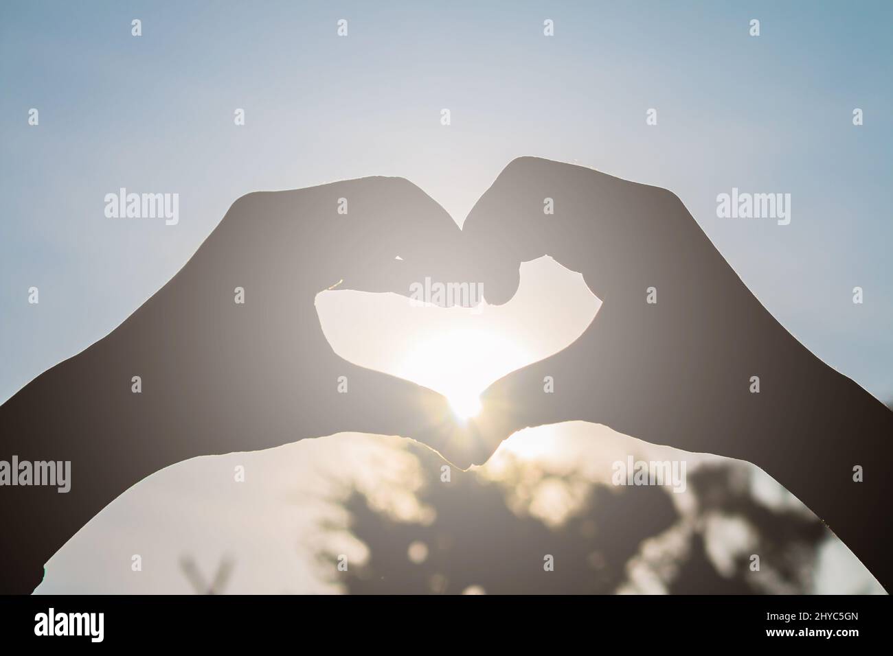 love shape hand silhouette at sunset background Stock Photo - Alamy