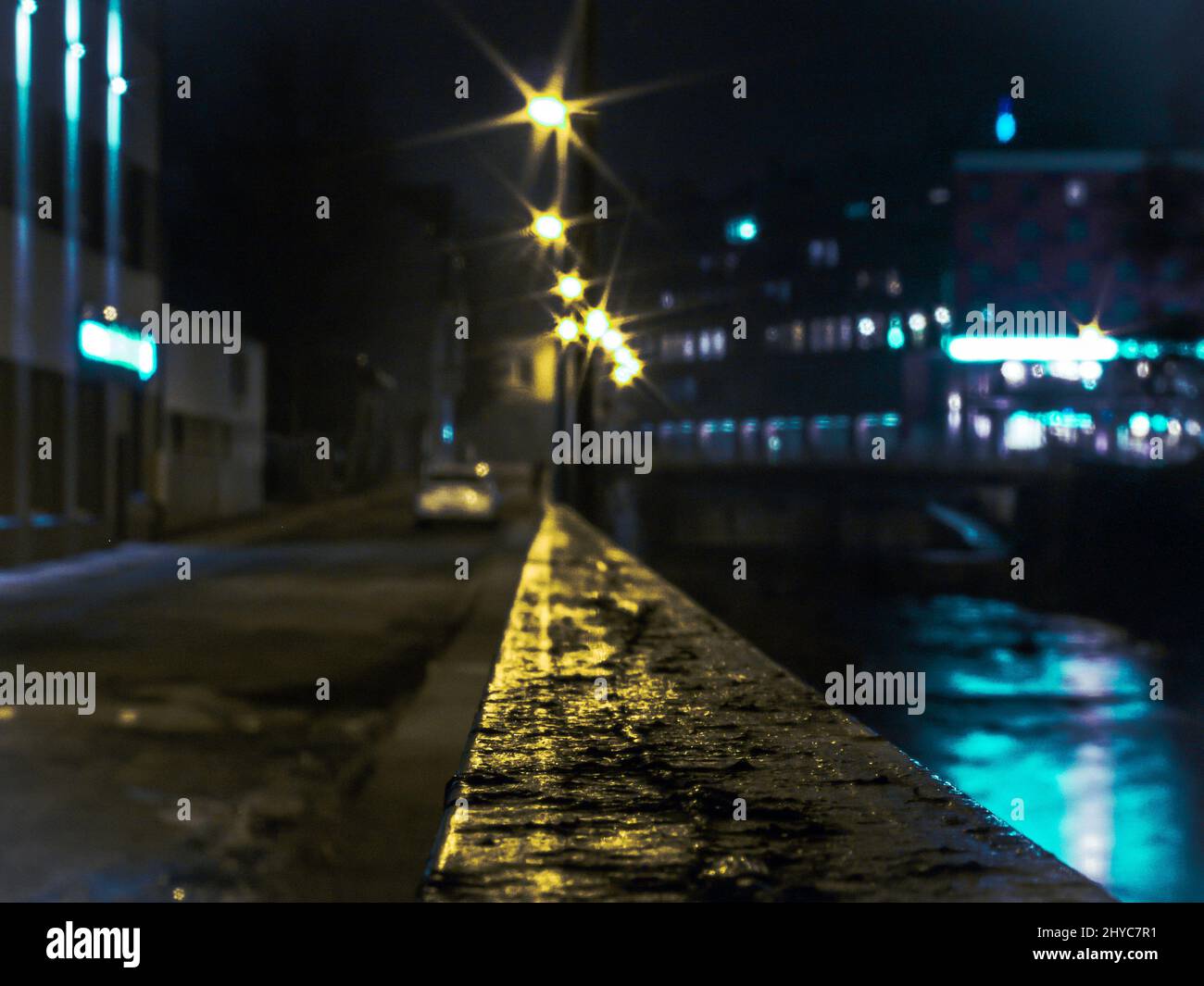 Empty dark city street with the lamps lightening it- shot from below ...