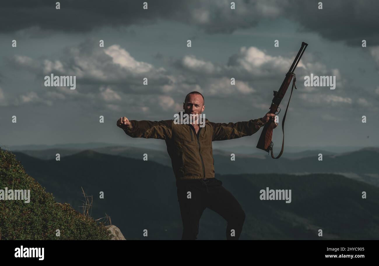 Excited Hunter with his rifle. Nature places for hunting. Hunter with ...