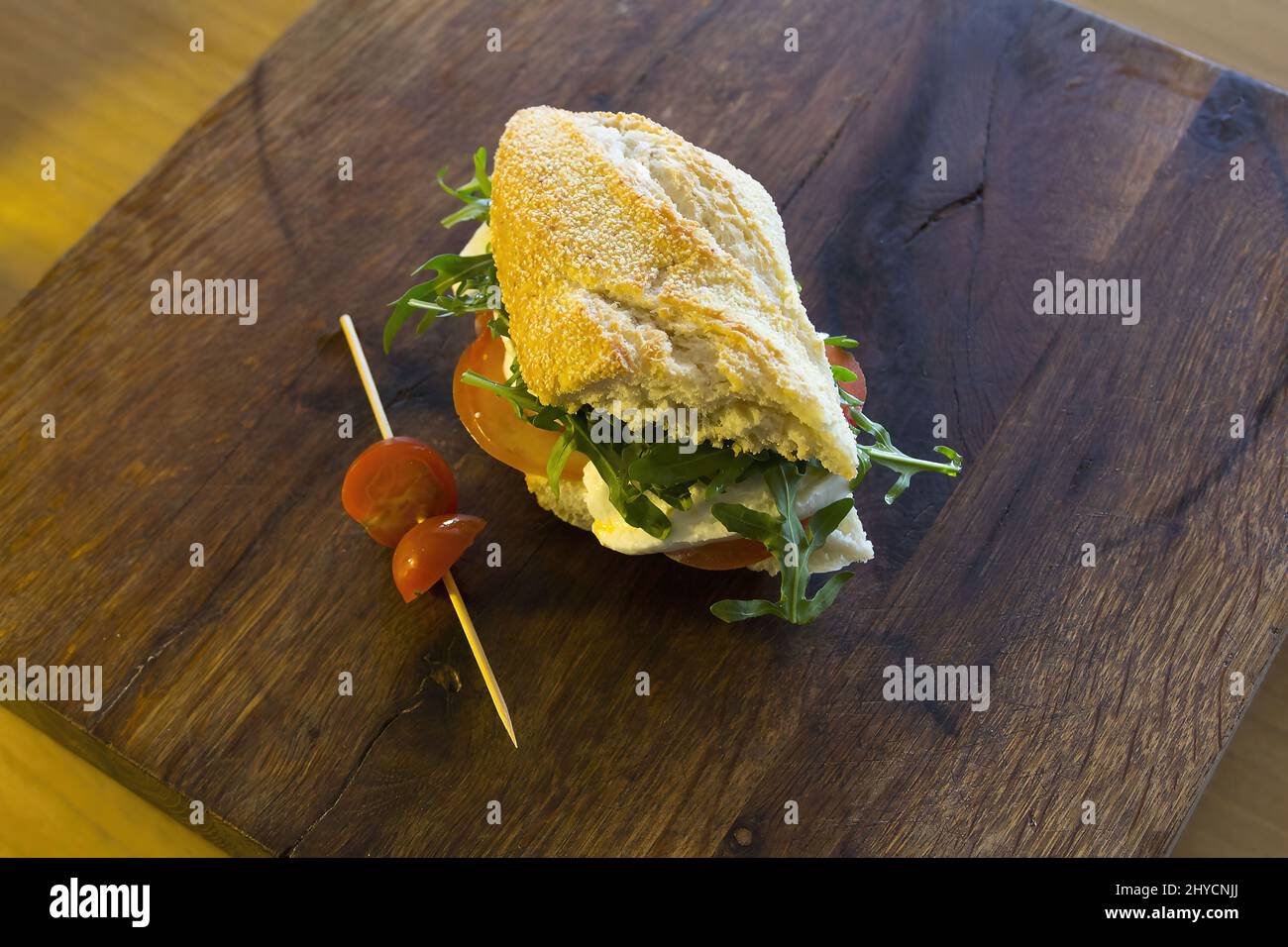 Top view of a sandwich with bread, tomatoes, herbs and cheese on a ...