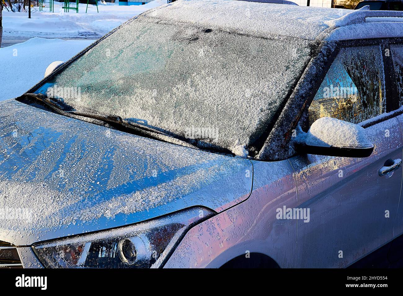 The windshield covered with frost at the car on a sun winter day Stock ...