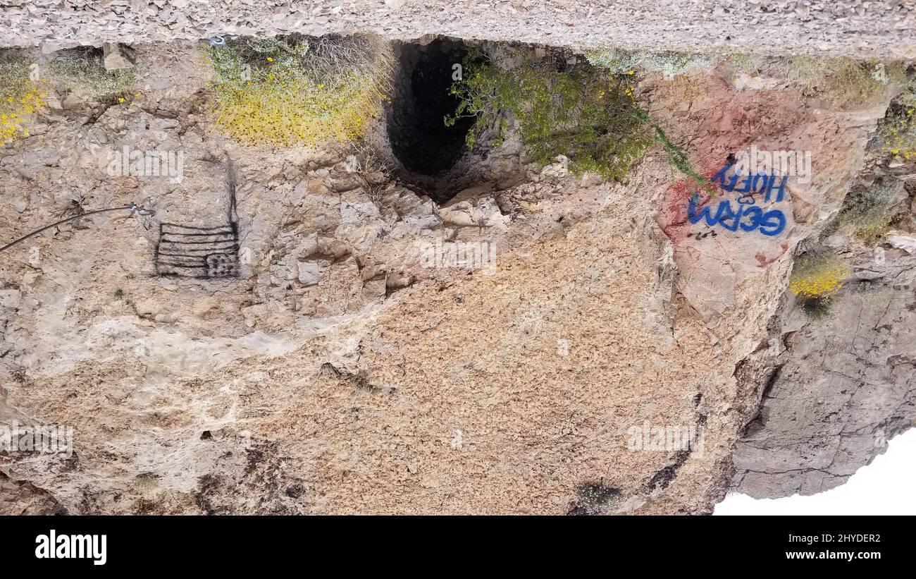 Shot of cave room in a rock wit element of vandalism Stock Photo - Alamy