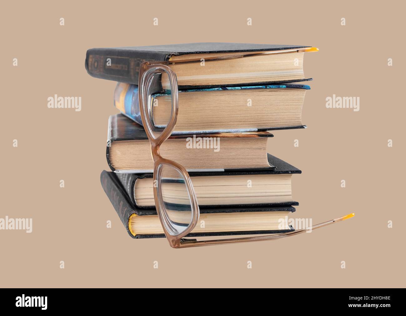 Books stack with eyeglasses on pastel background. Reading, knowledge ...