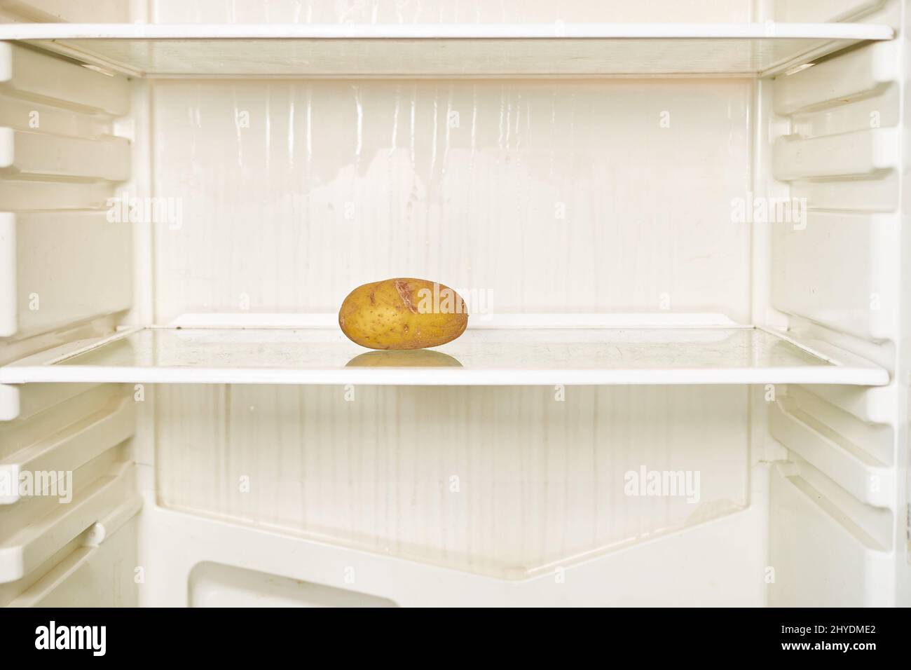 Spoiled potato is on the shelf of an empty refrigerator Stock Photo - Alamy