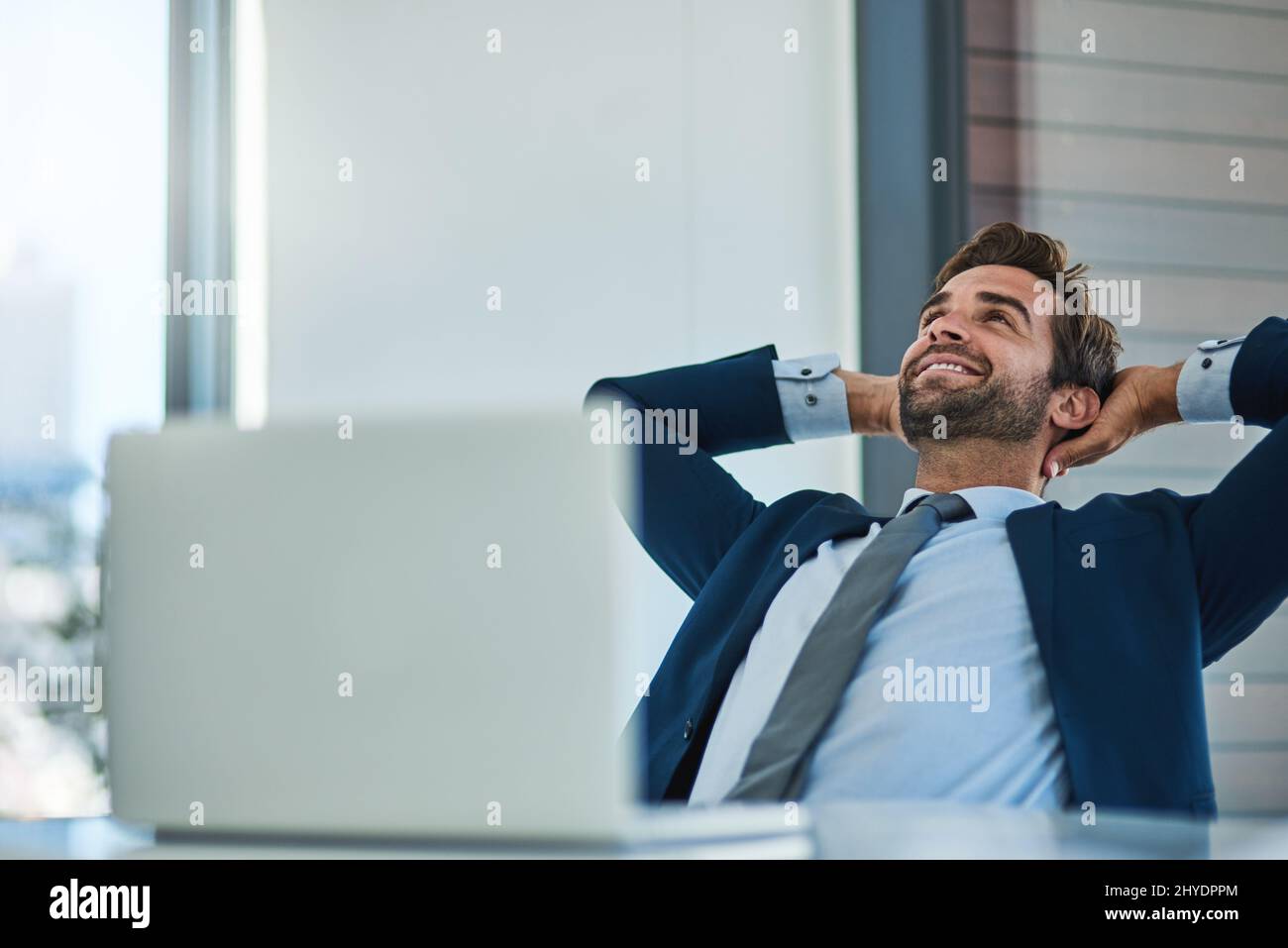 Things are finally going my way. Shot of a young corporate businessman ...