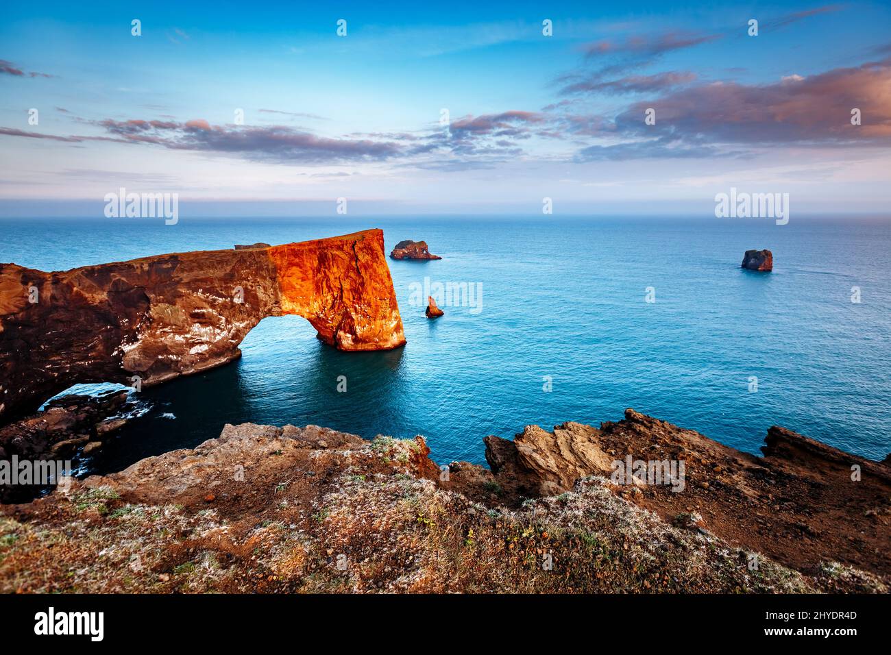 Amazing black arch of lava standing in the sea on small peninsula ...