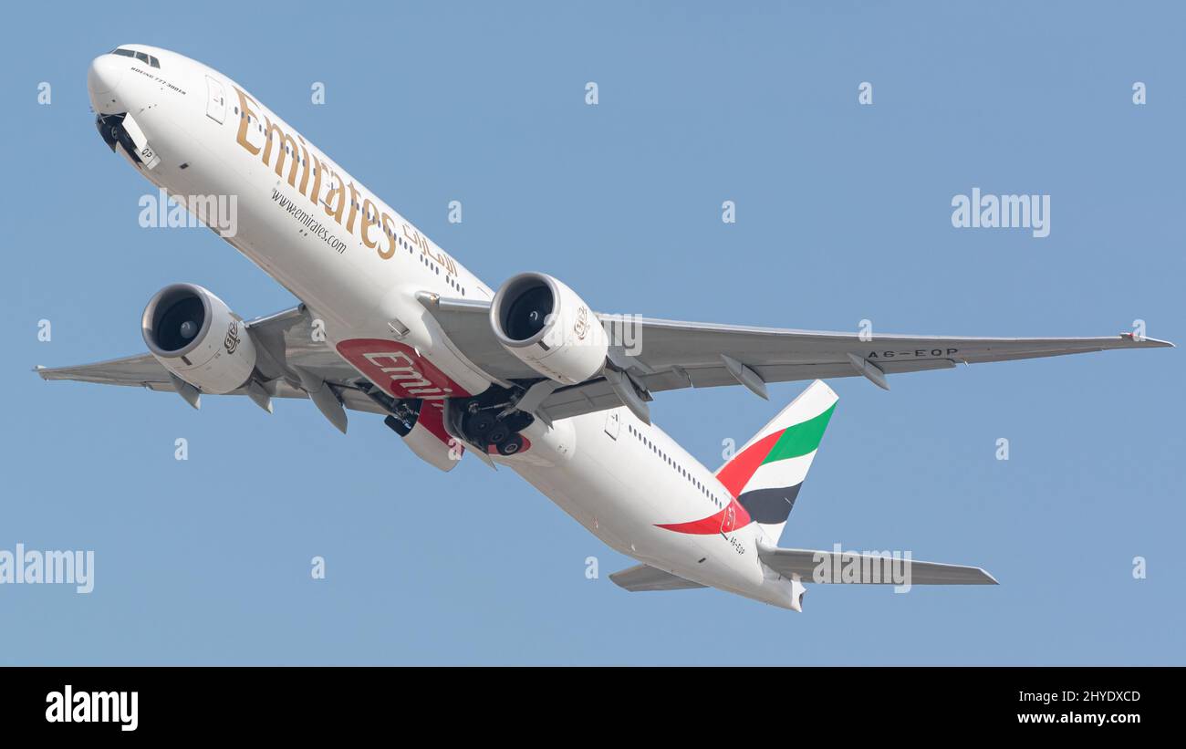 Low-angle shot of a Boeing 777 of emirates airline flying against the ...