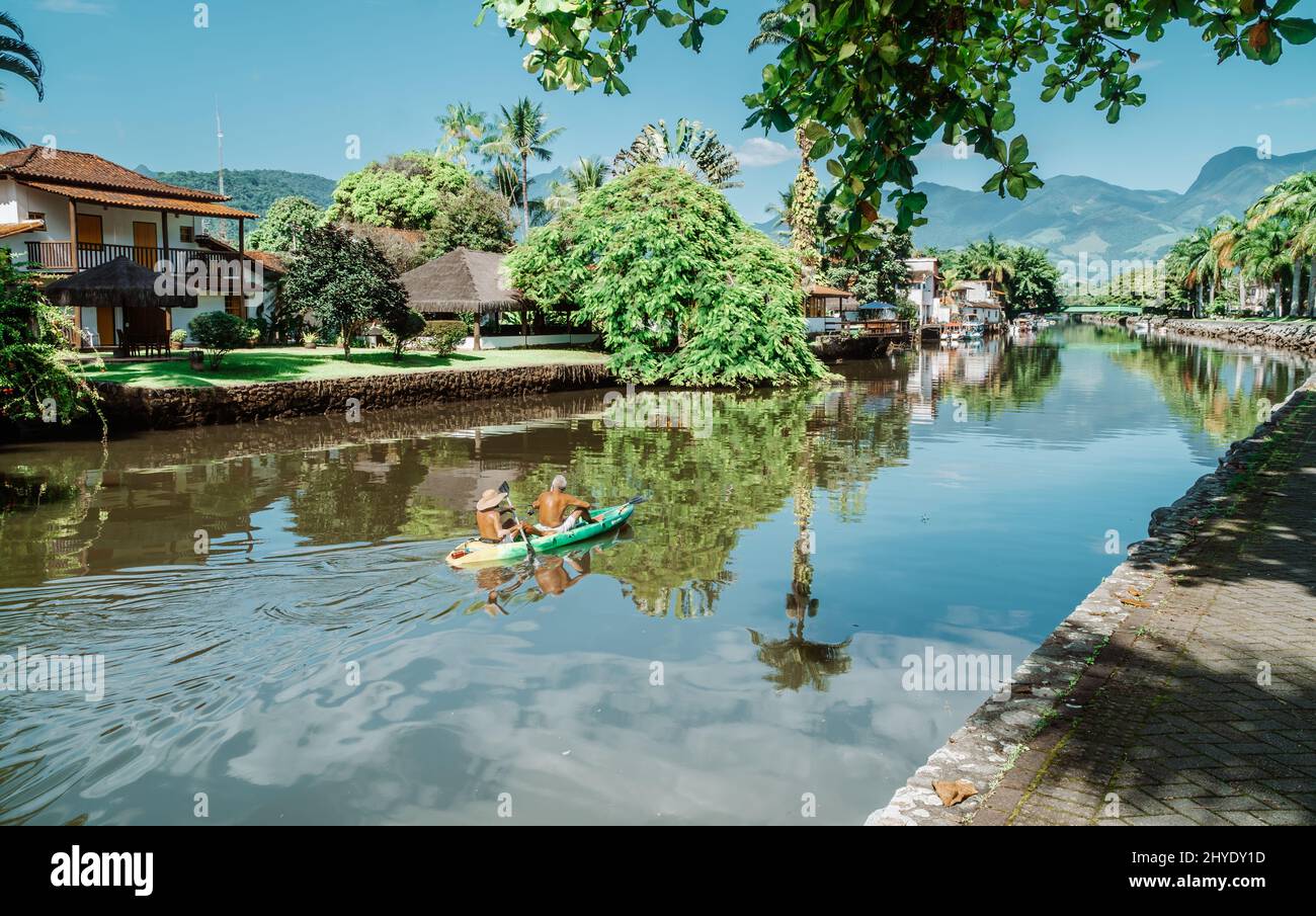 Two people paddling a canoe on the river Stock Photo - Alamy