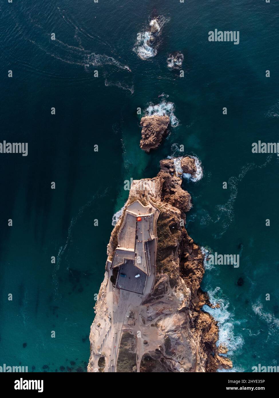 Aerial shot of a huge rock on the transparent sea Stock Photo - Alamy