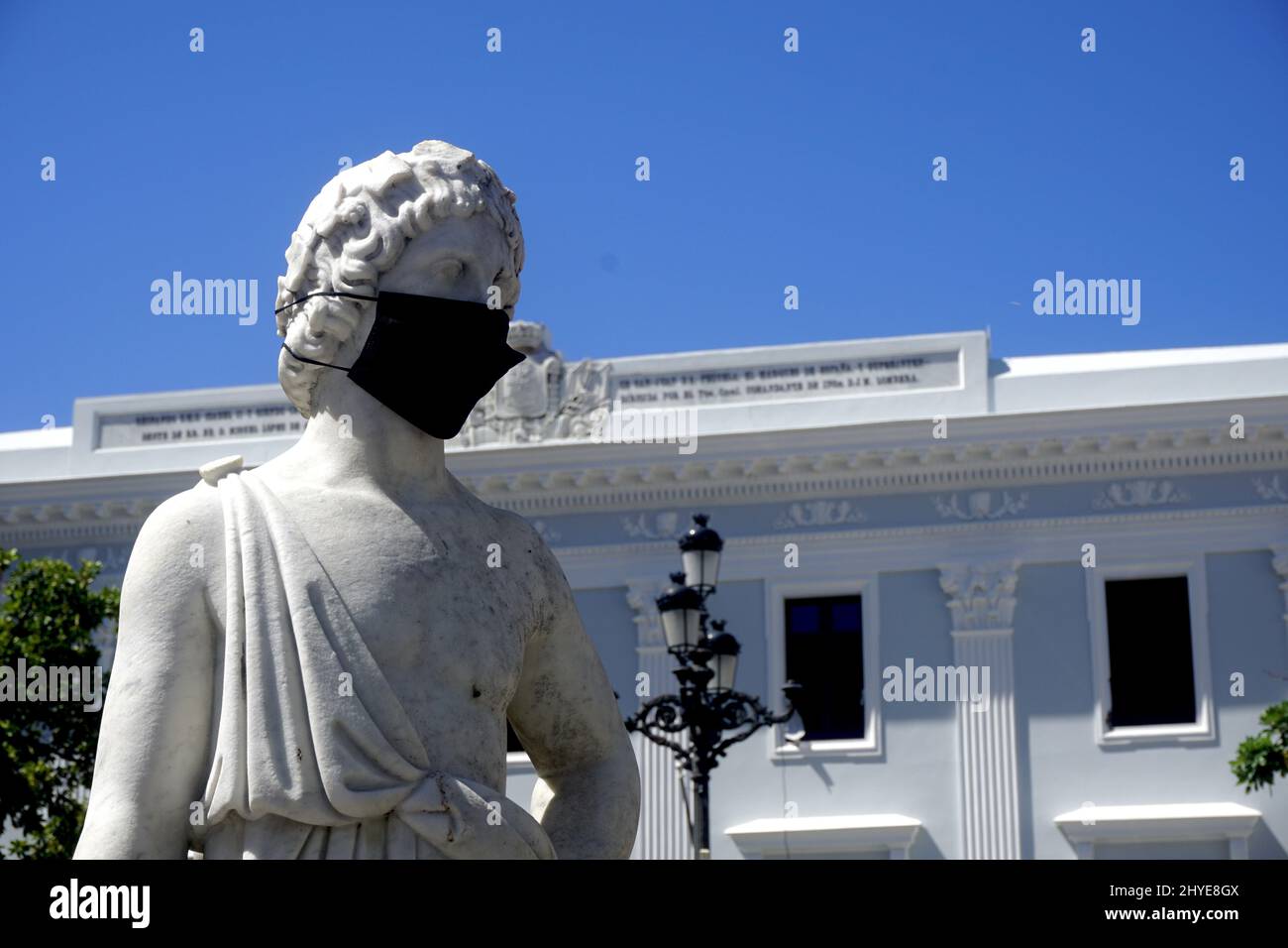 White marble statue with a black mask for covid protection in San Juan ...