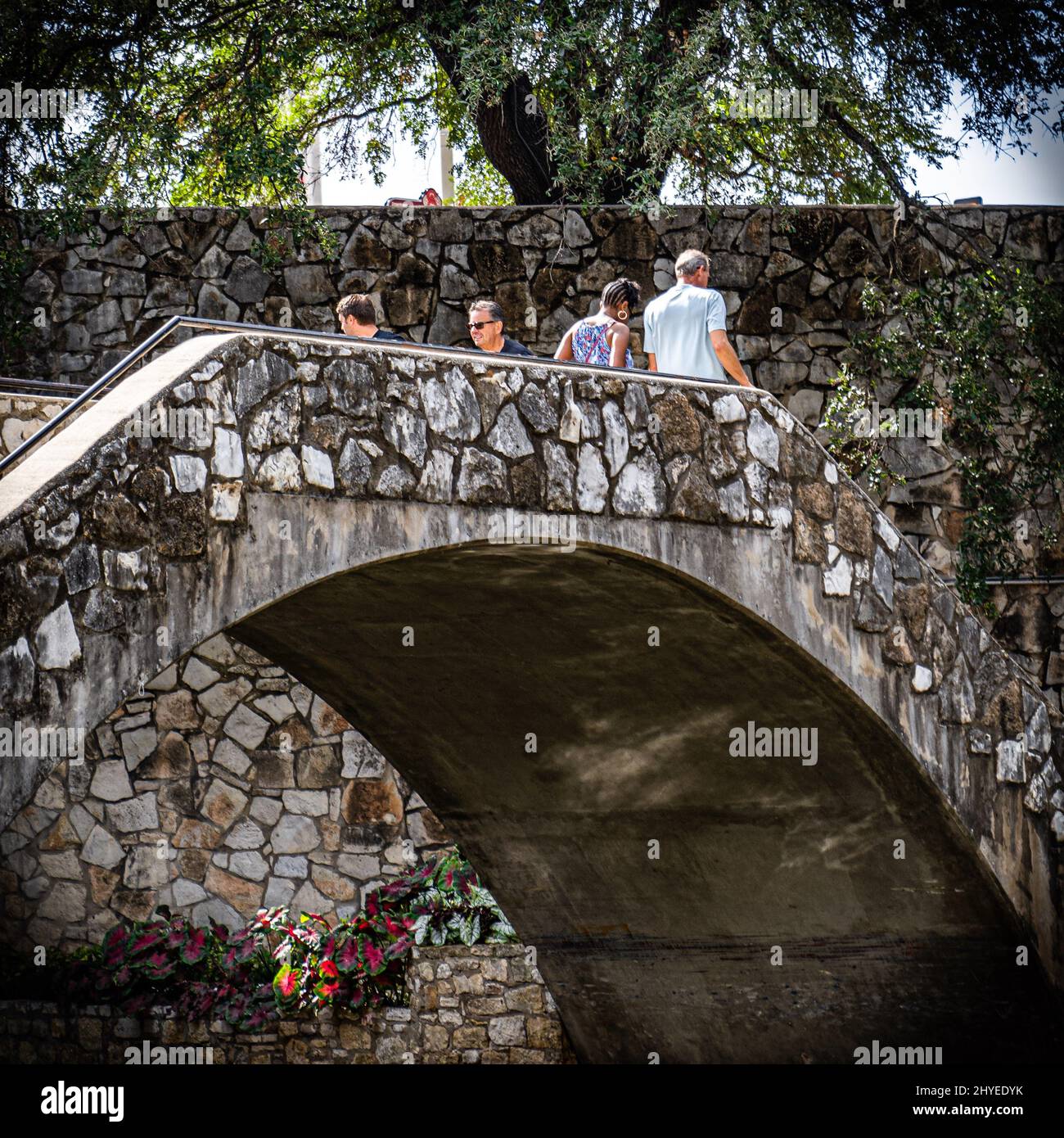 Beautiful view of people on a stone bridge in a park Stock Photo - Alamy