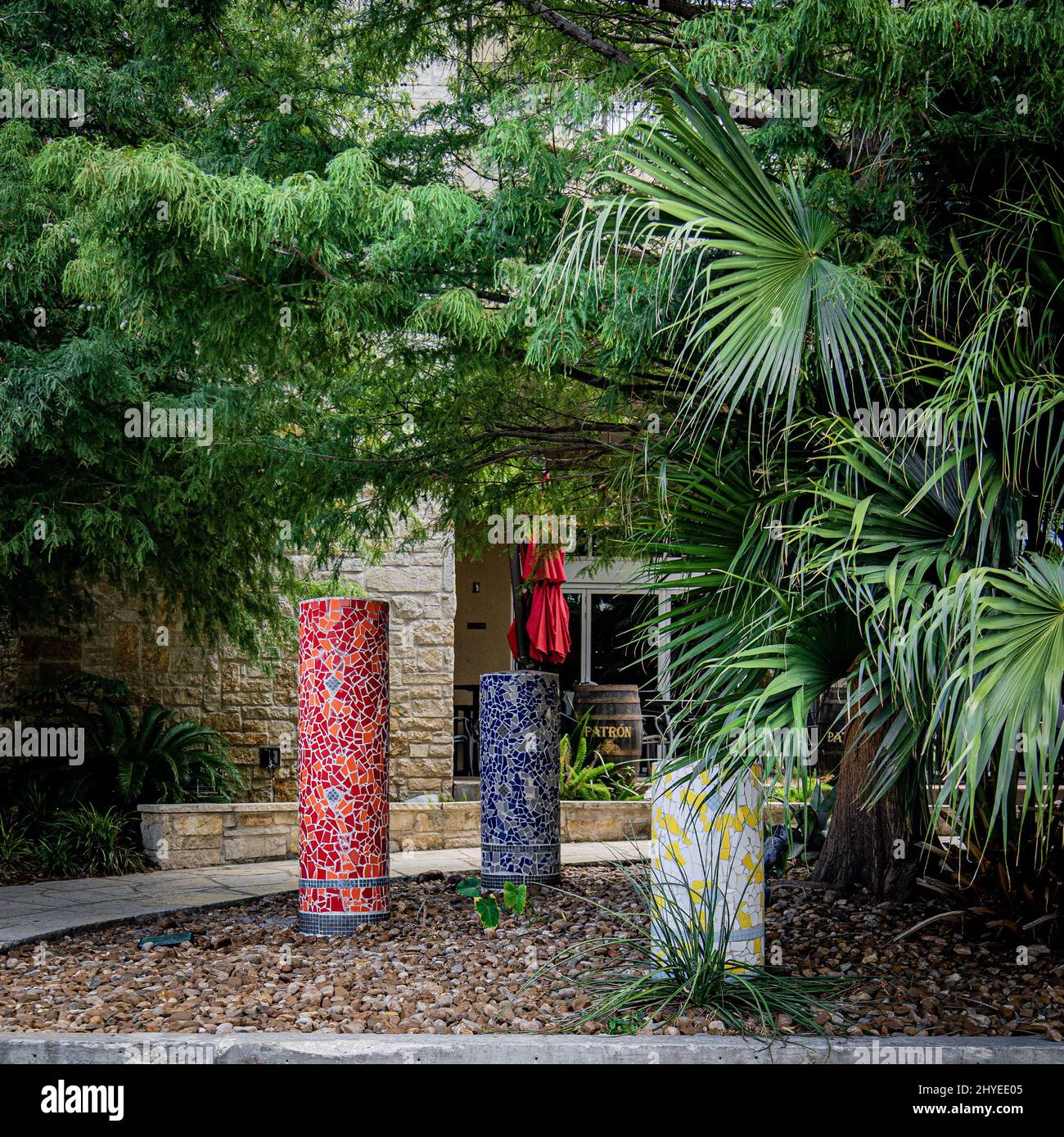 Beautiful view of palm trees and colorful columns in the garden Stock ...