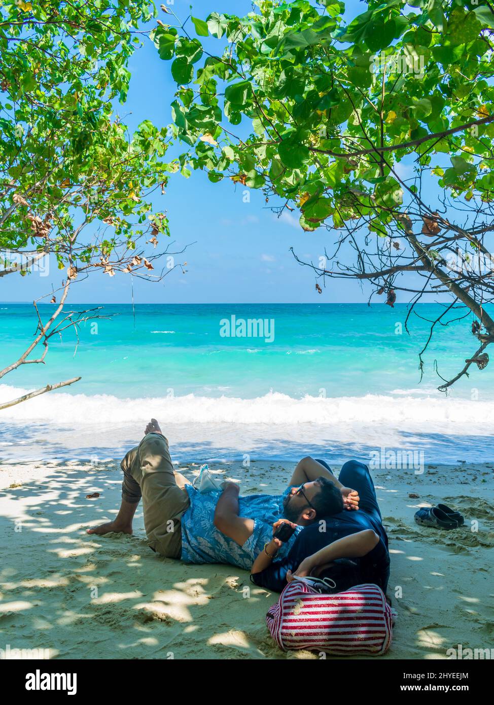 A couple relaxing on the beach, Havelock Island, Andaman, India Stock ...