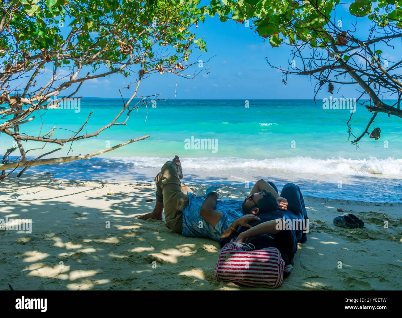 A couple relaxing on the beach, Havelock Island, Andaman, India Stock ...