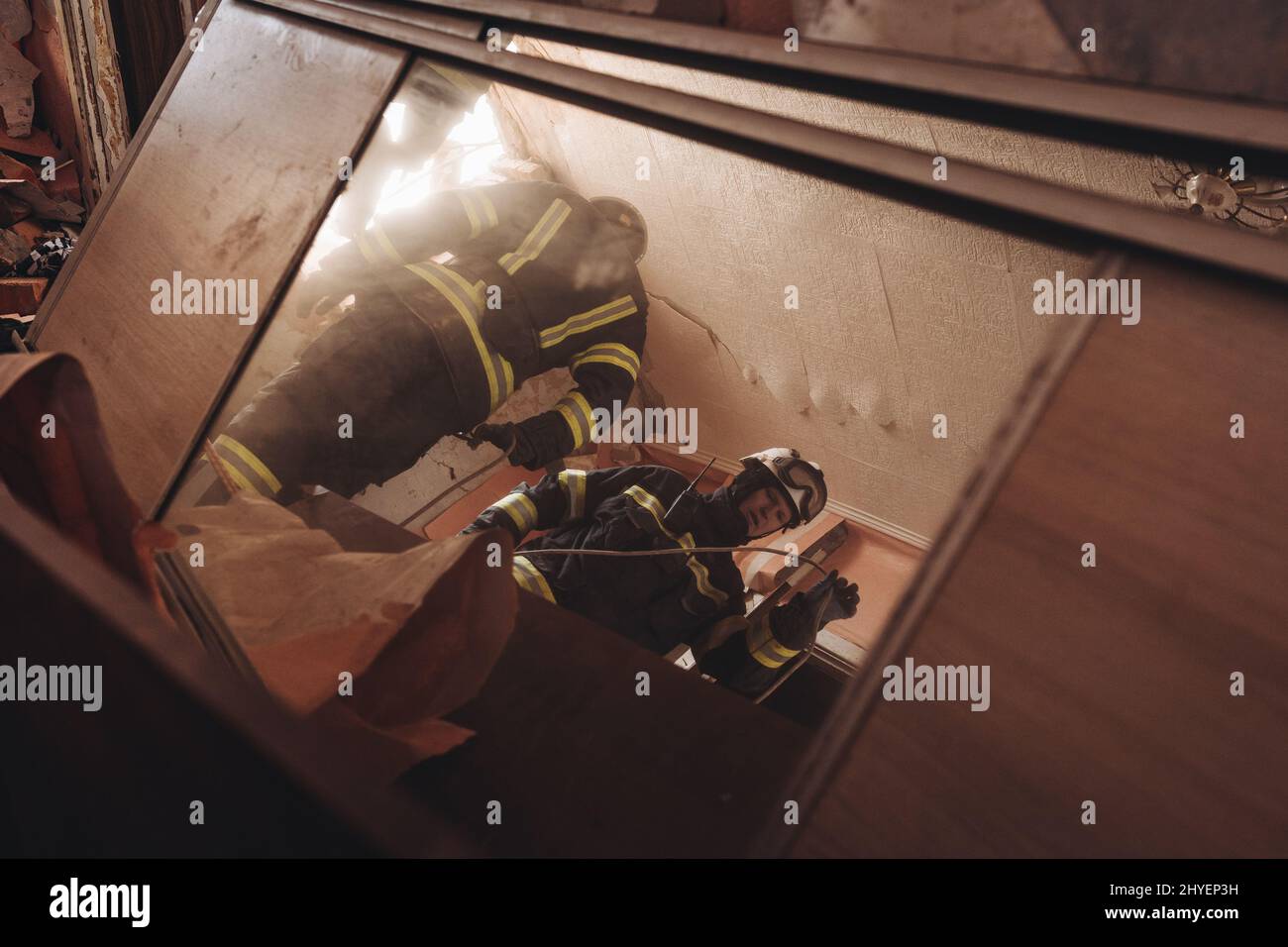 Kharkiv, Ukraine. 13th Mar, 2022. Firefighters work inside a building ...