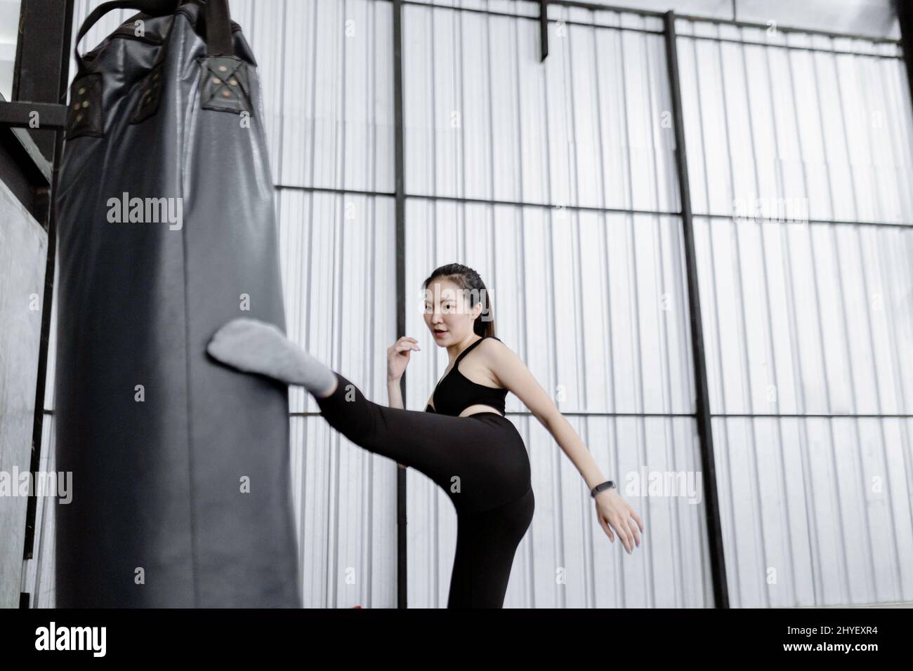 exercise concept The boxing woman being concentrated on knocking the ...