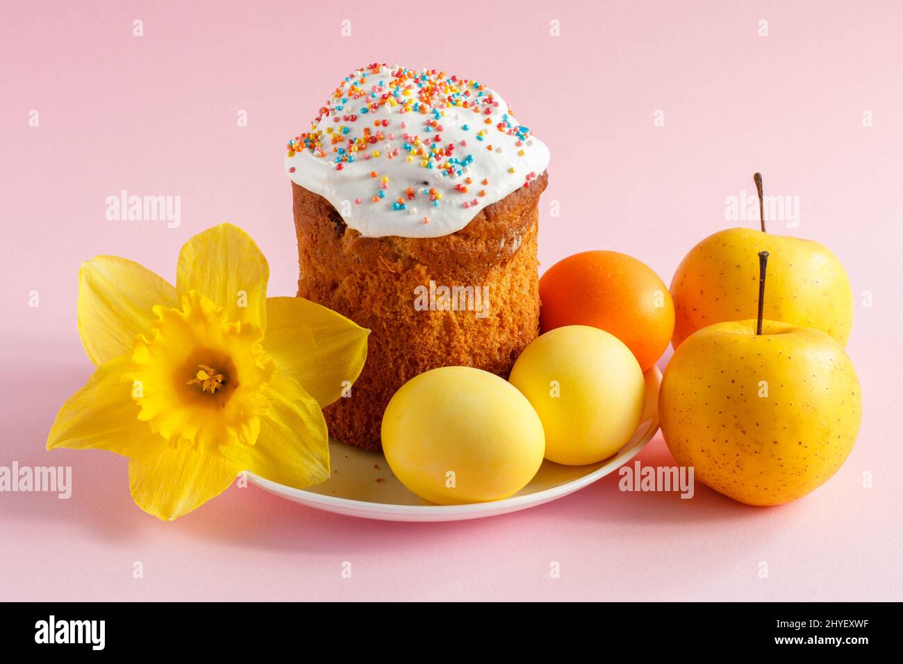 Easter cake, colorful Easter eggs, apples and a daffodil flower ...