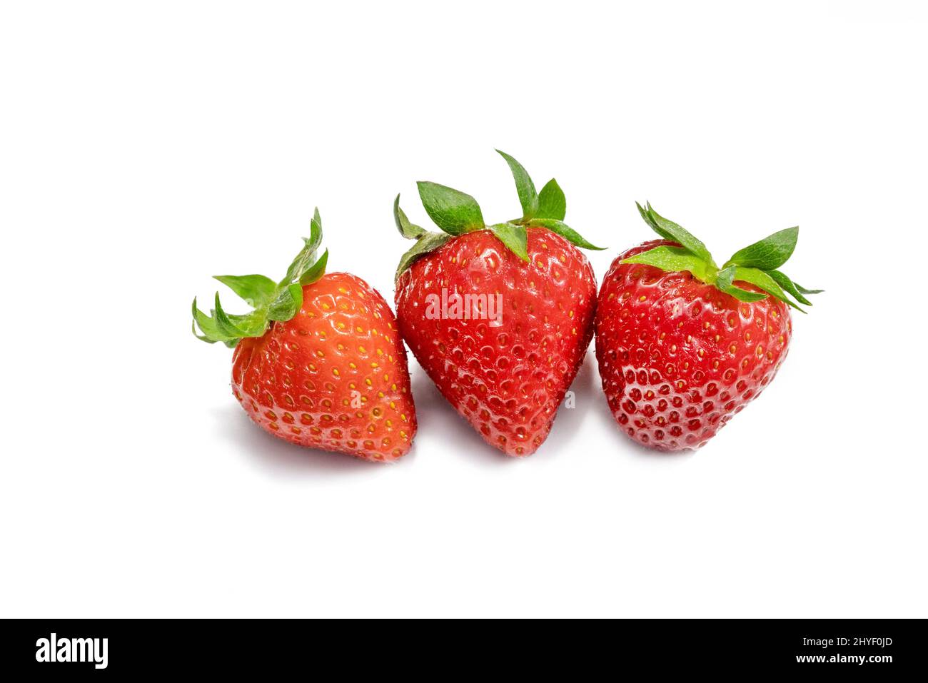 Strawberries isolated. Whole strawberries with leaves on a white ...