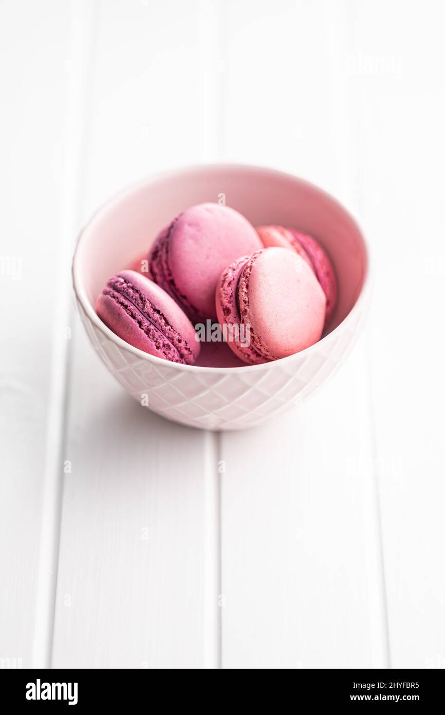 Sweet pink macarons. Traditional french macaroons. Tasty dessert in a ...