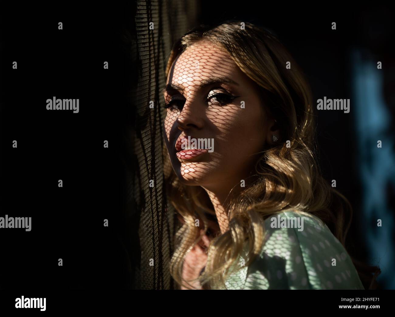 Woman face in shadow. Close up face of young stylish woman. Beautiful ...