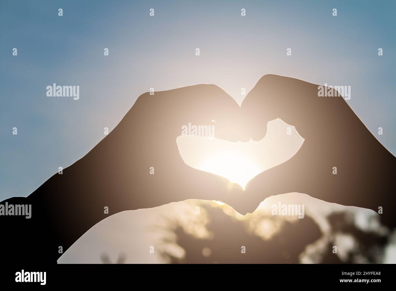 love shape hand silhouette at sunset background Stock Photo - Alamy