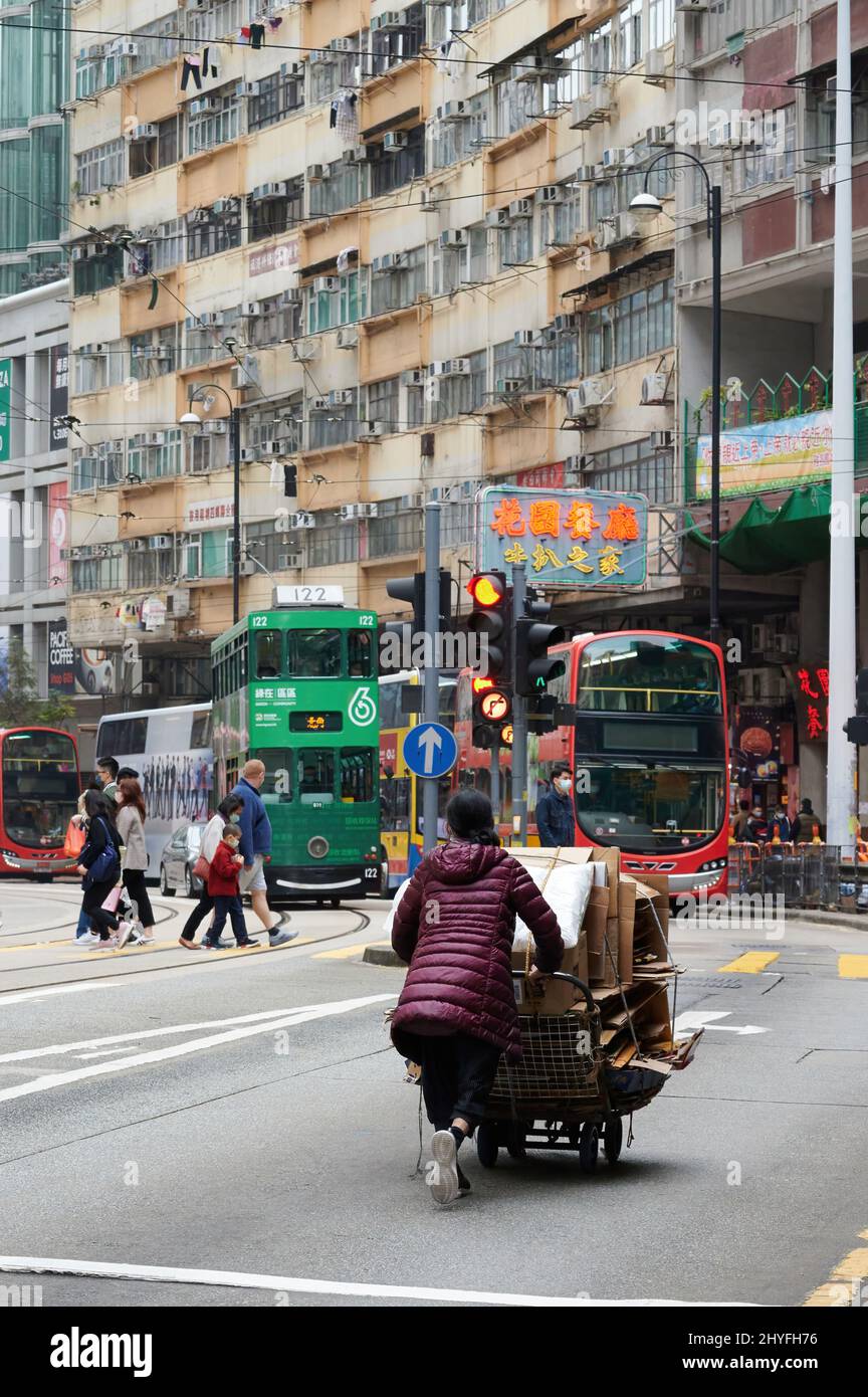 Vertical shot of crowded road with tall buildings in Hong Kong Stock ...