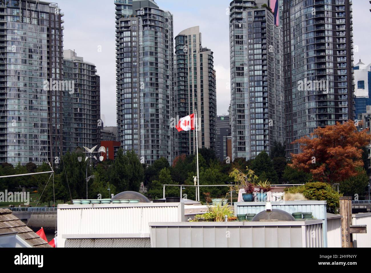 Canadian flag with the residential high rises in downtown Vancouver, British Columbia, Canada ...